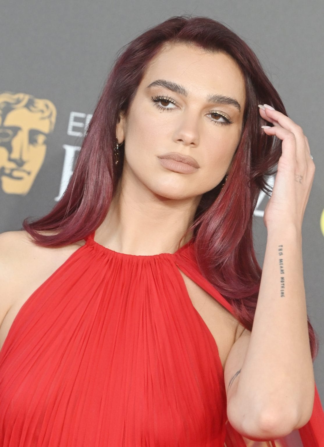 Red-Haired Radiance: Dua Lipa Makes Dramatic Entrance in Fiery Hot Valentino Gown at BAFTA Film ...