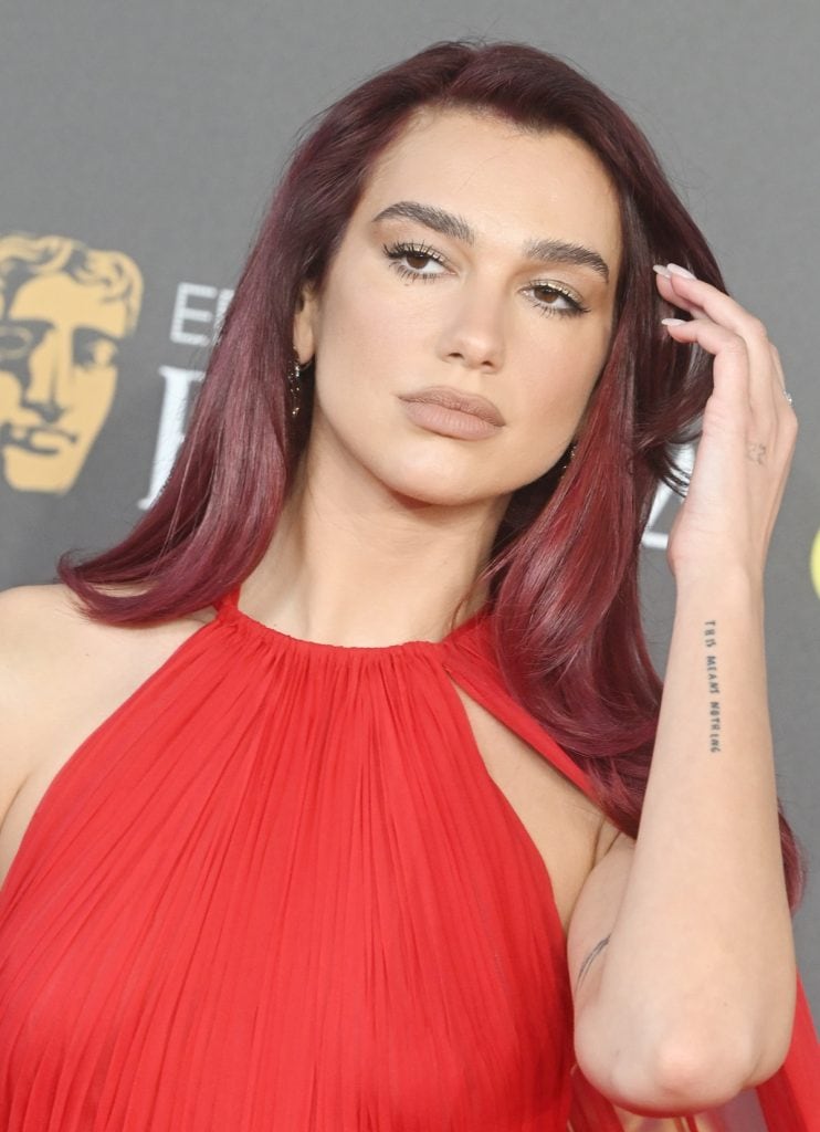 Red-Haired Radiance: Dua Lipa Makes Dramatic Entrance in Fiery Hot Valentino Gown at BAFTA Film ...